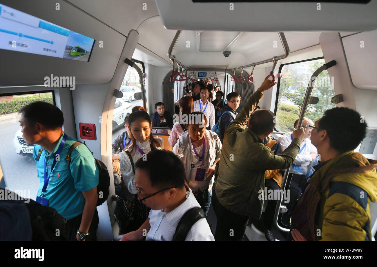 Passengers take a ride on a railless train, developed by the CRRC ...
