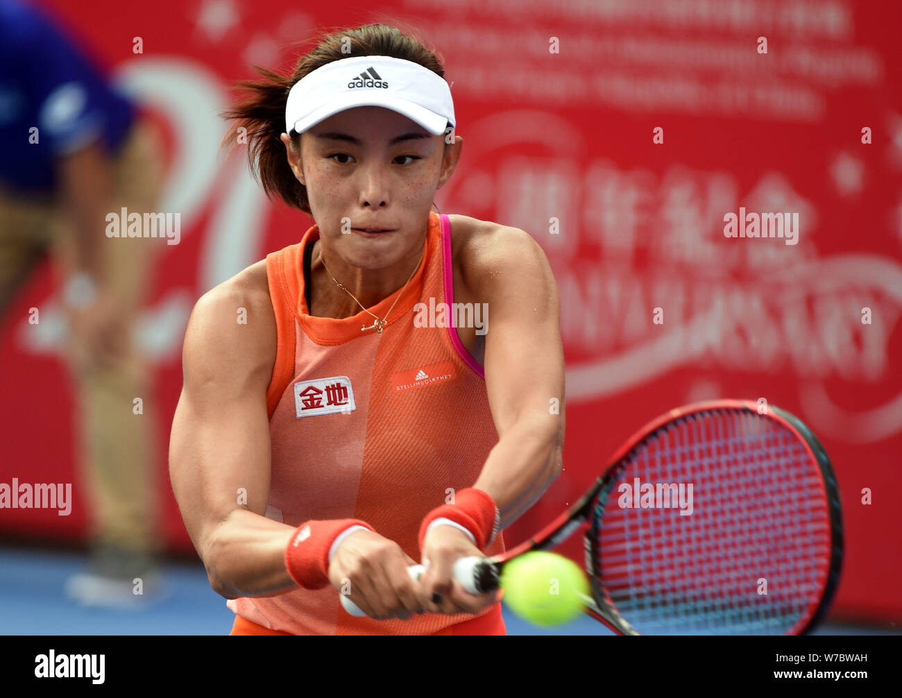 Wang Qiang of China returns a shot to Luksika Kumkhum of Thailand in ...