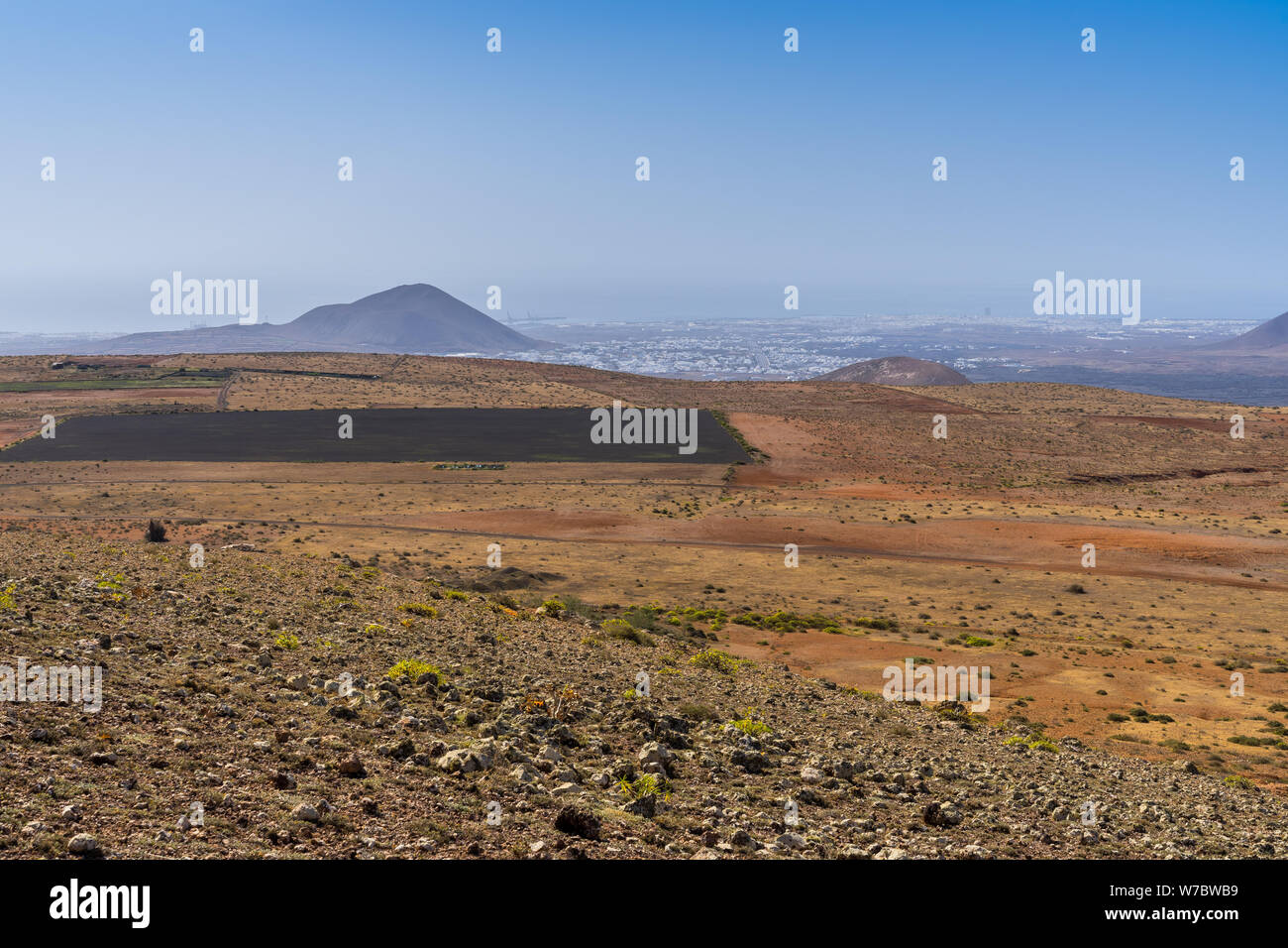Spain, Lanzarote, Coastline of city arrecife behind colorful volcanic ...