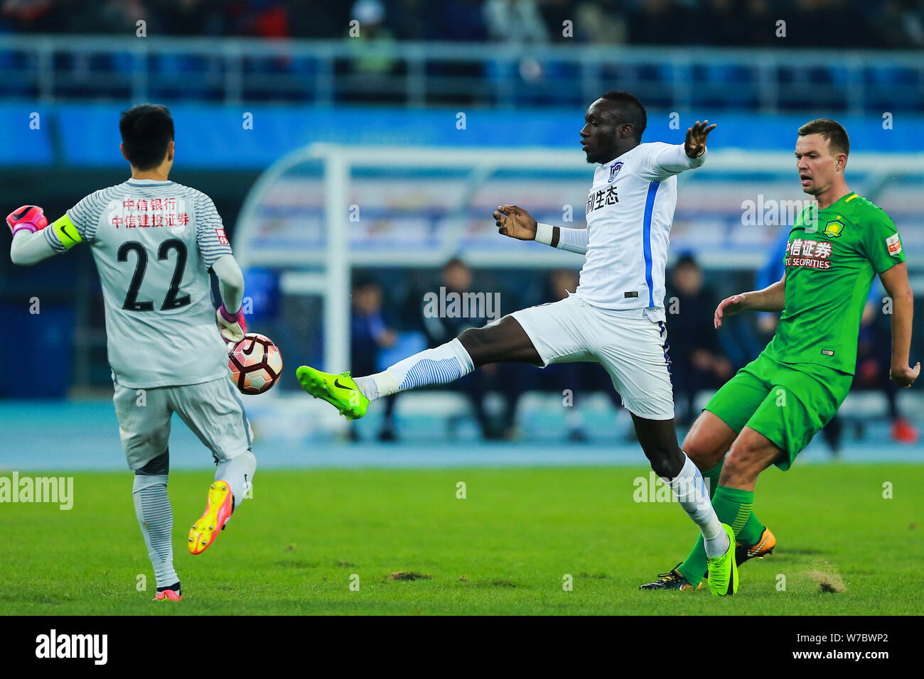 Senegalese football player Mbaye Diagne, left, of Tianjin TEDA kicks ...