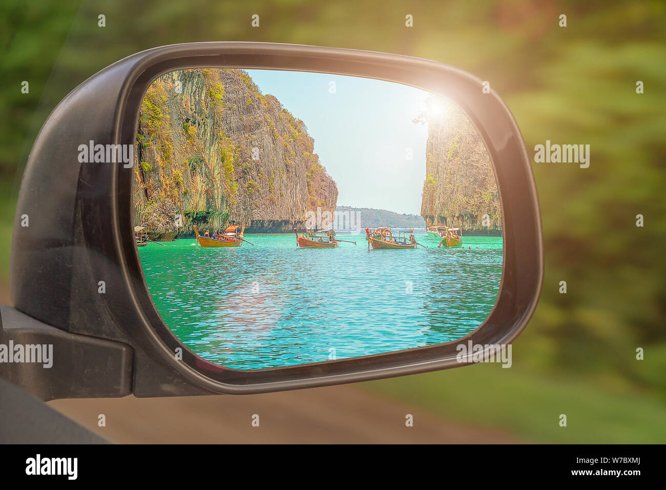 Landscape in the sideview mirror of a car , on road countryside. In the ...
