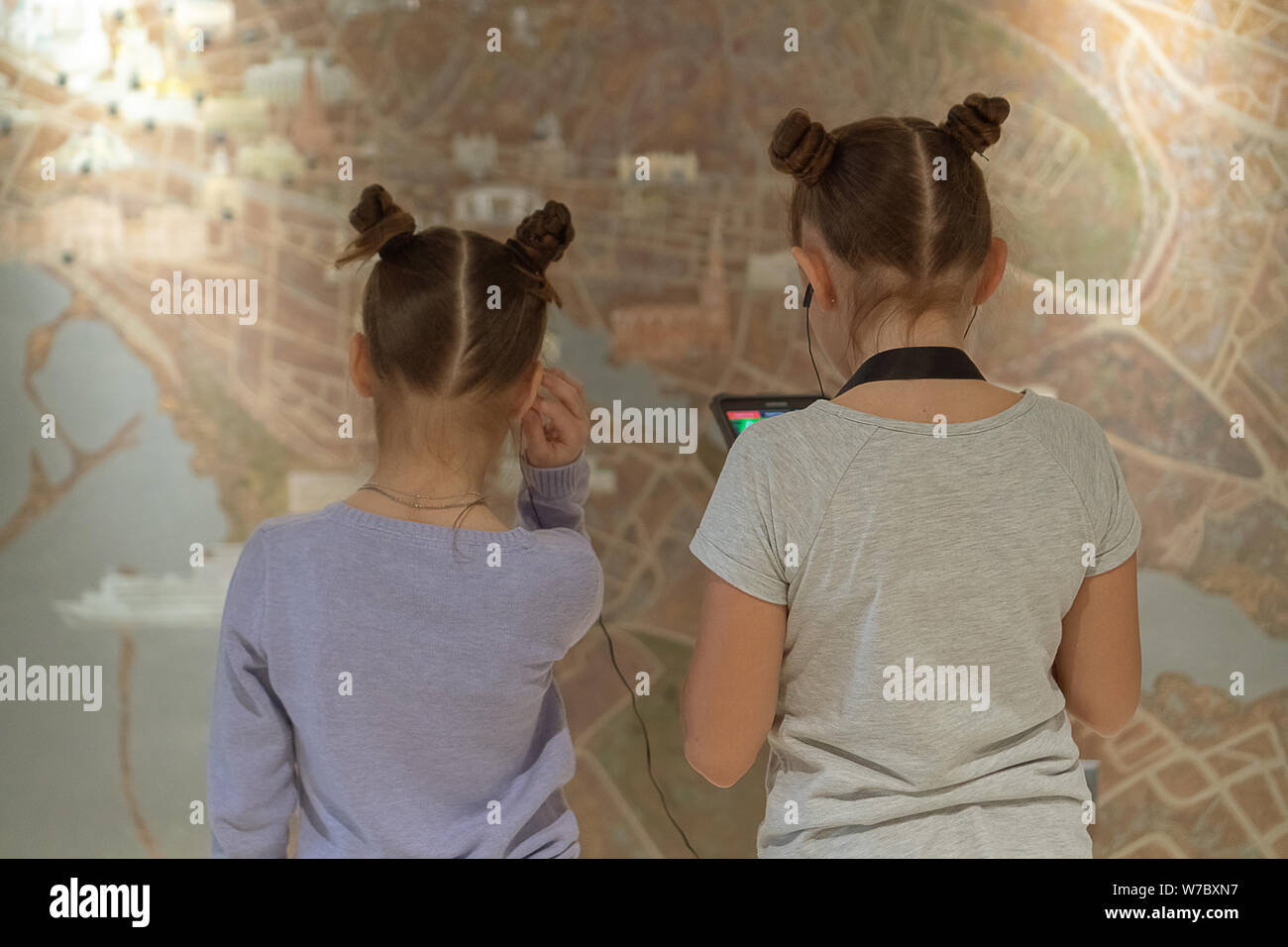 girls in museum listening to interesting information about exhibit ...