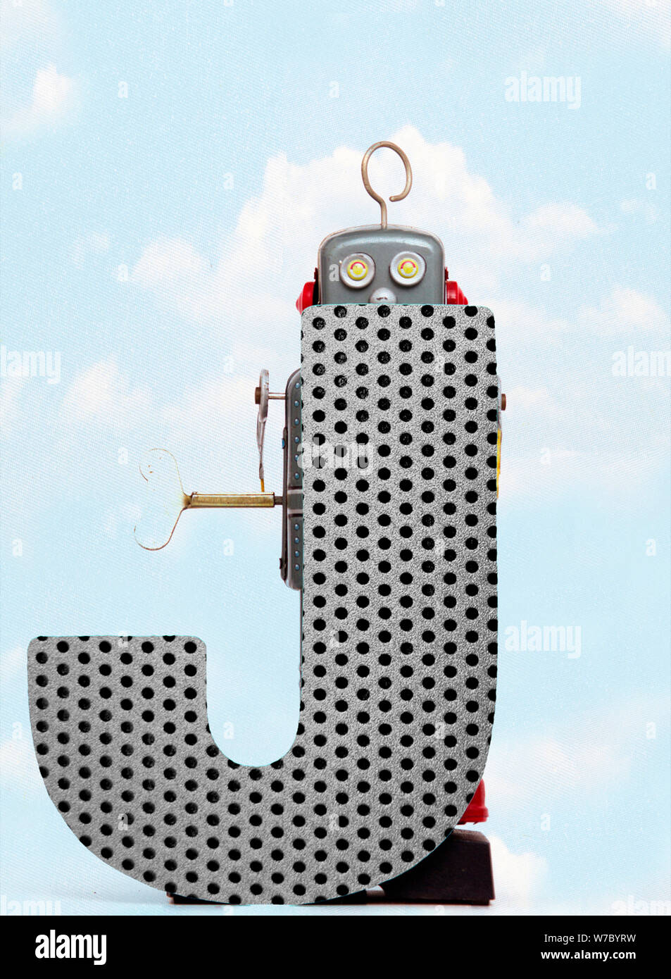 retro robots holding a big metal letter J with blue sky and clouds ...