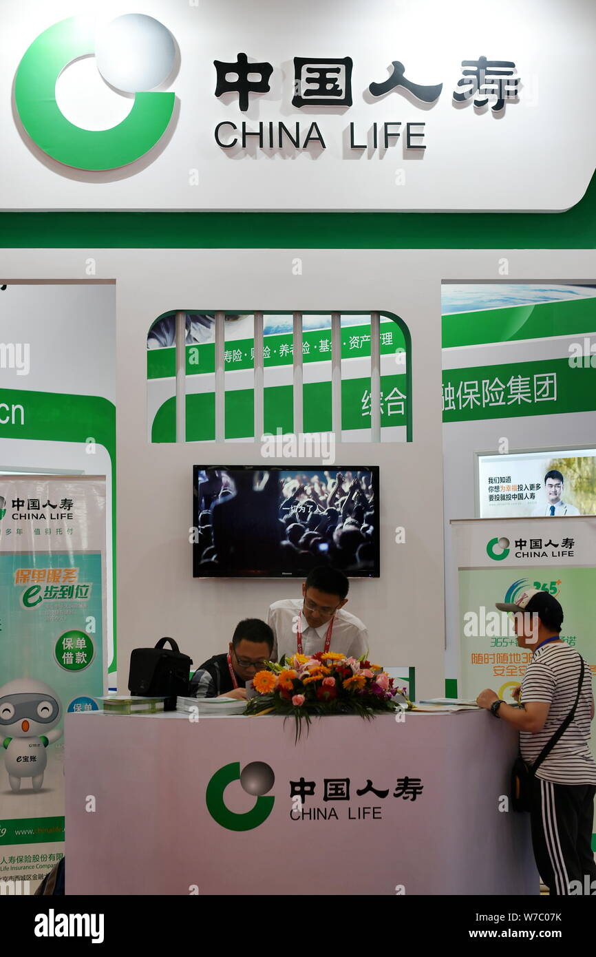 --FILE--Chinese employees are seen at the stand of China Life Insurance ...