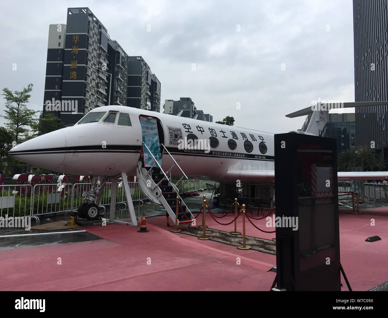 A private airplane is on display in front of a shopping mall in ...