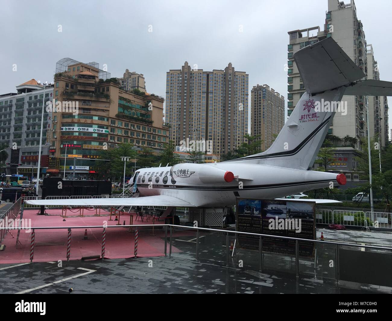 A private airplane is on display in front of a shopping mall in ...