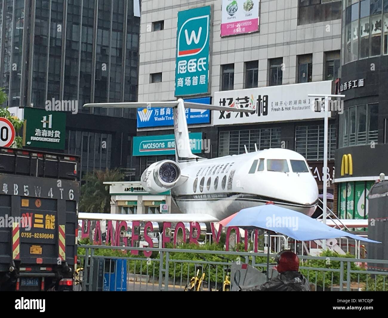 A private airplane is on display in front of a shopping mall in ...