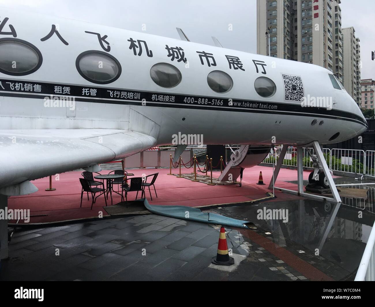 A private airplane is on display in front of a shopping mall in ...