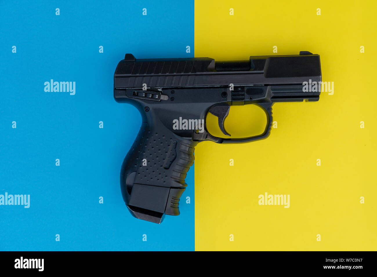 close up image of pistol on a multicolored background . Black gun on a ...