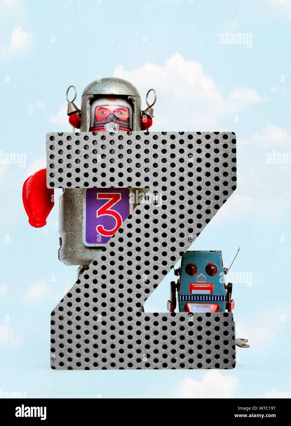 retro robots holding a big metal letter Z with blue sky and clouds ...