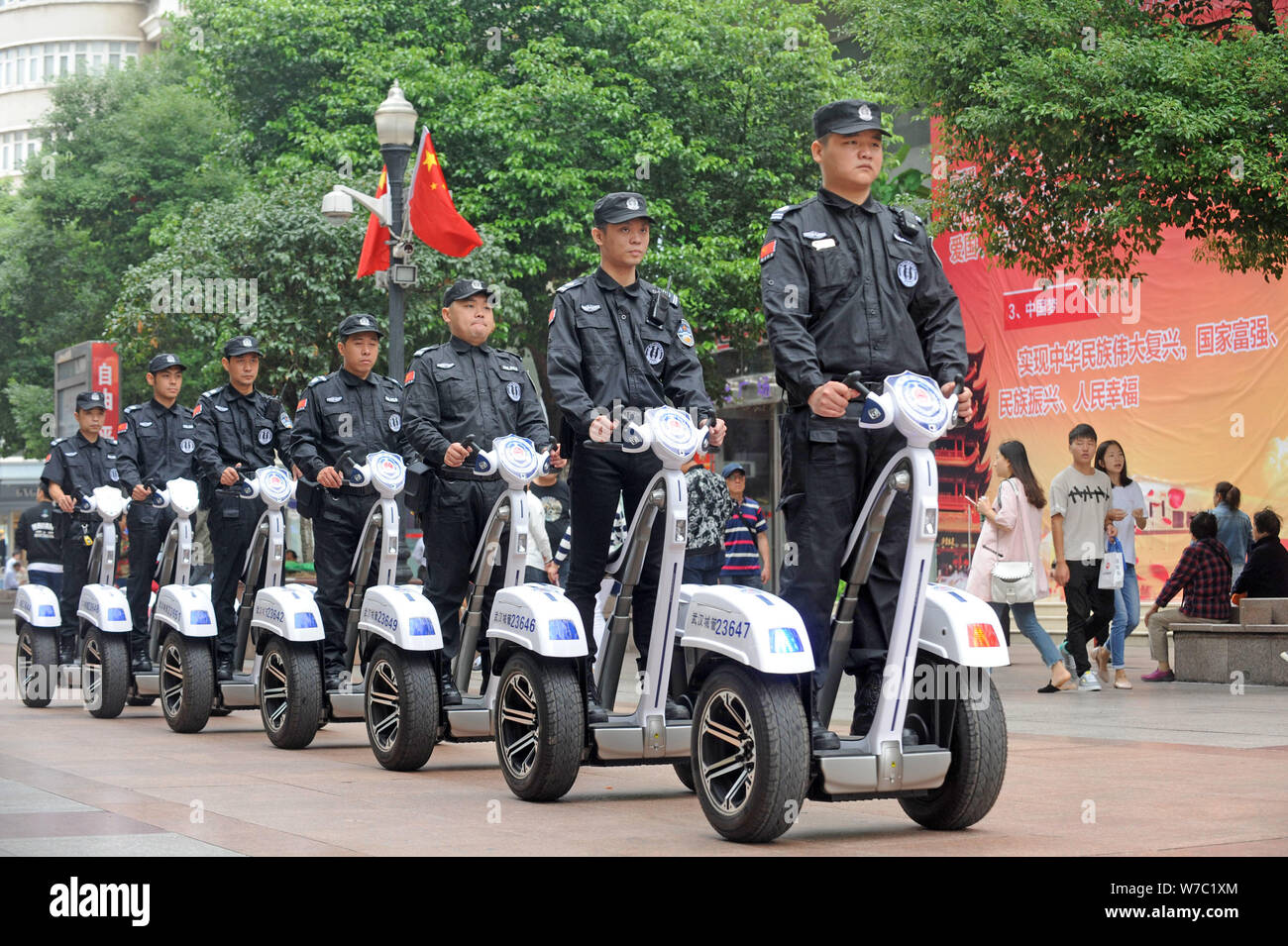Chinese urban enforcement officers, also known as chengguan, ride self ...