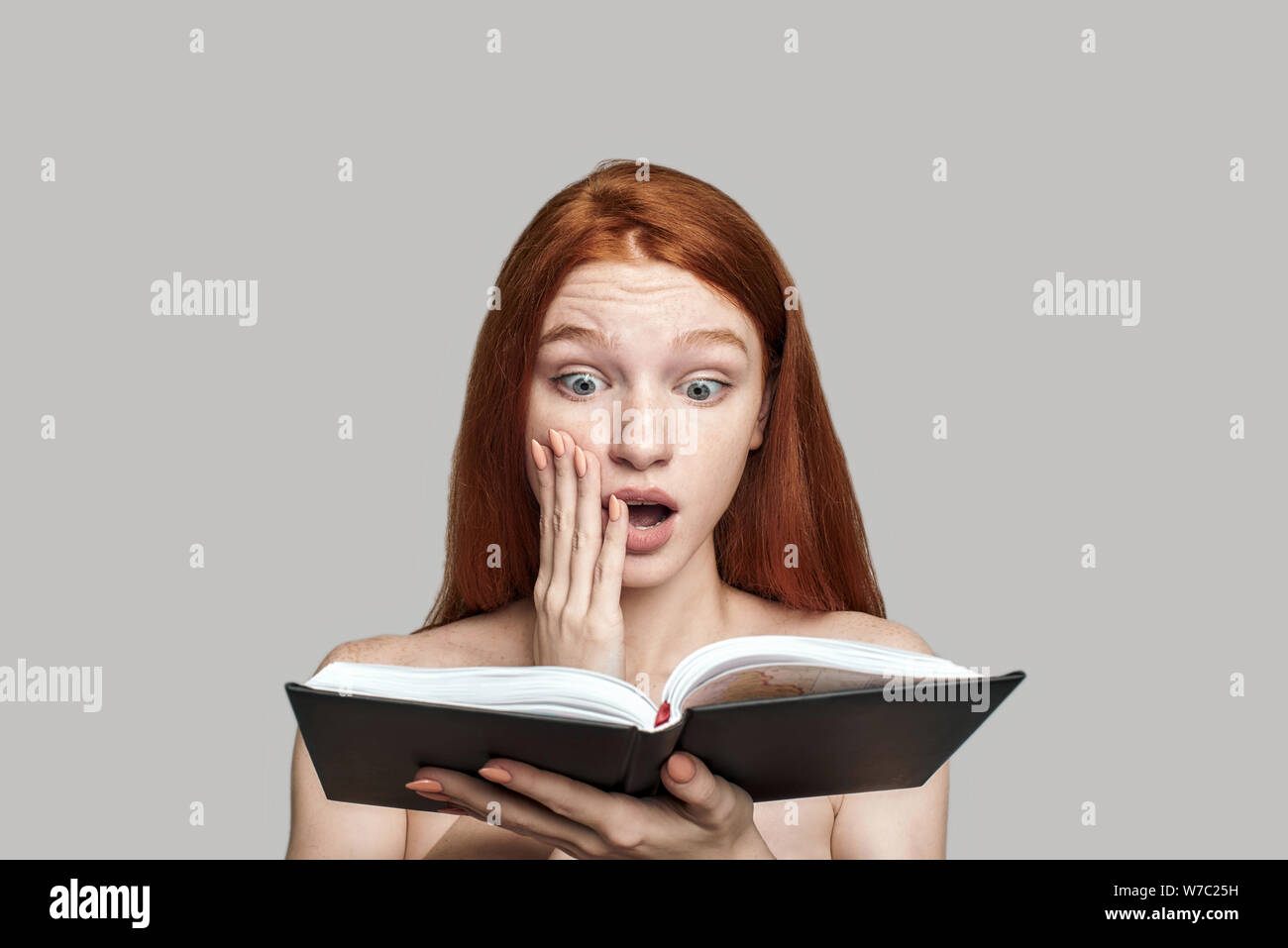 Woman shock reading book library hi-res stock photography and images ...