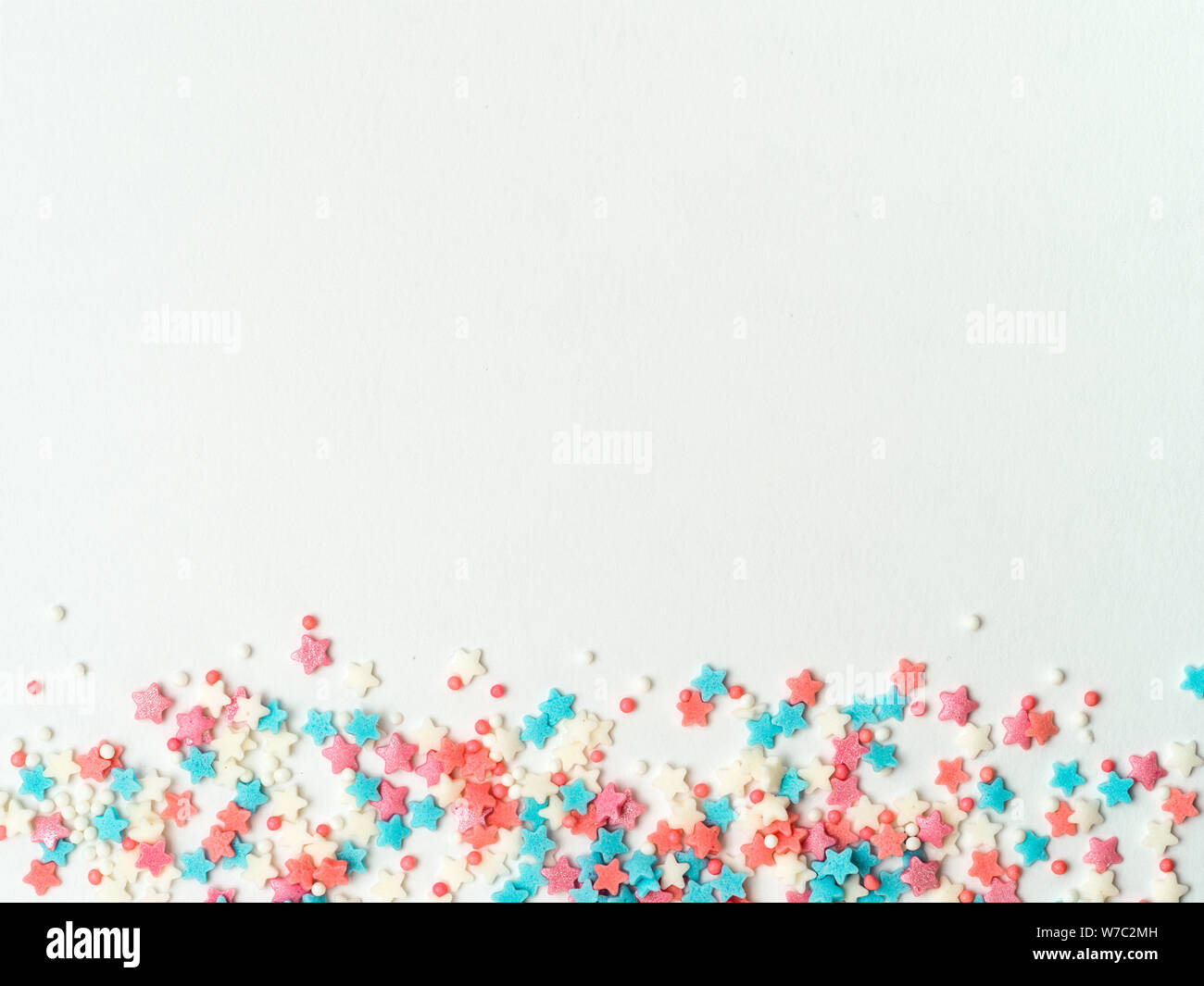 Festive border frame of colorful pastel sprinkles on white background ...