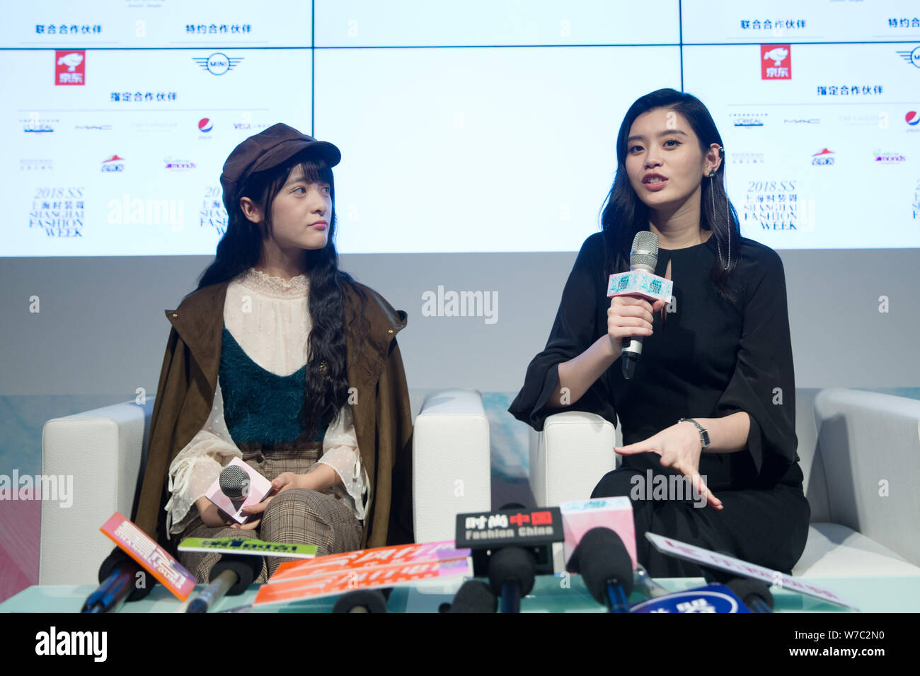 Chinese model Xi Mengyao, right, better known as Ming Xi, attends the fashion show of Anirac ...