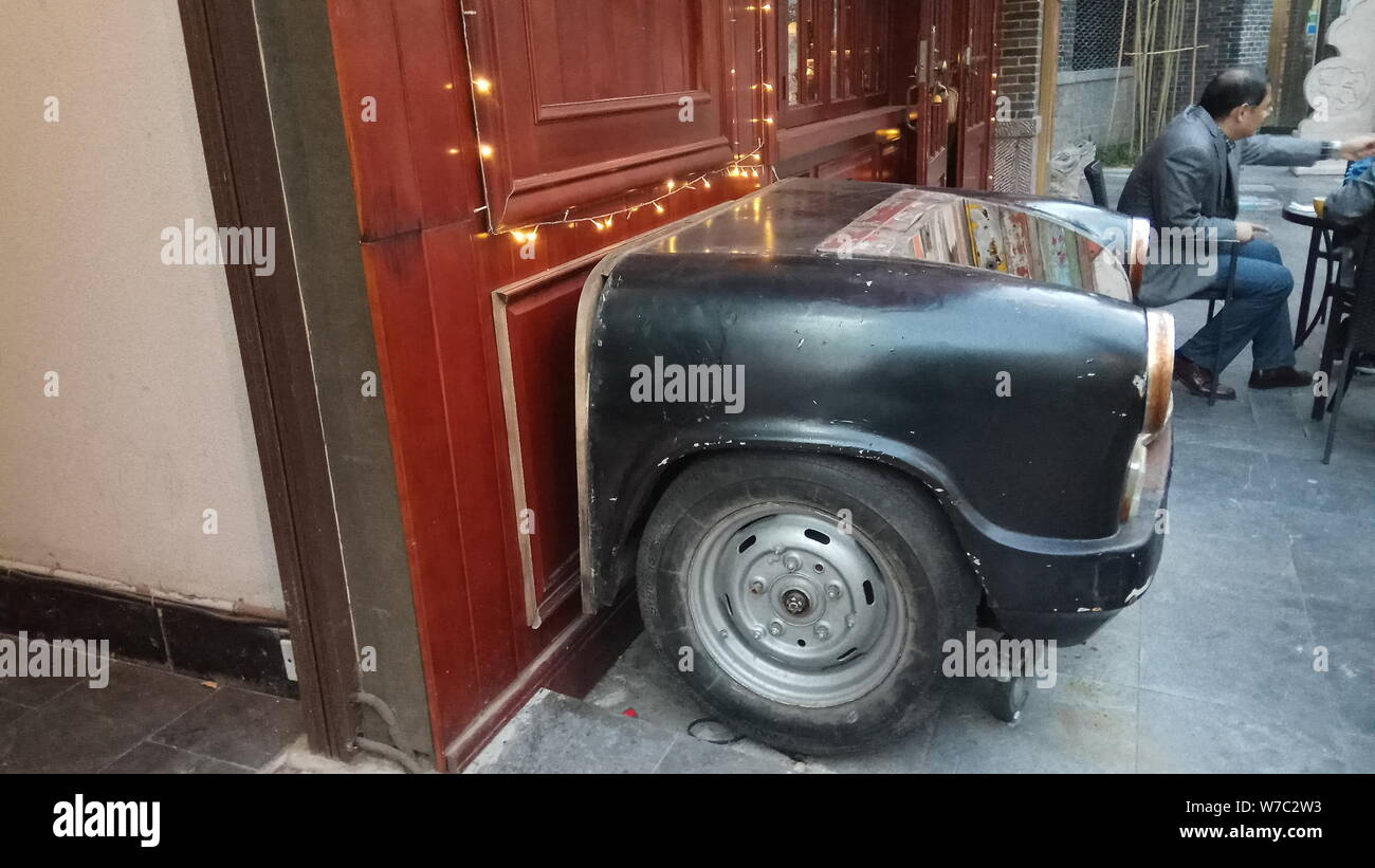 A customer is seen near the front part of a Mercedes-Benz car ...