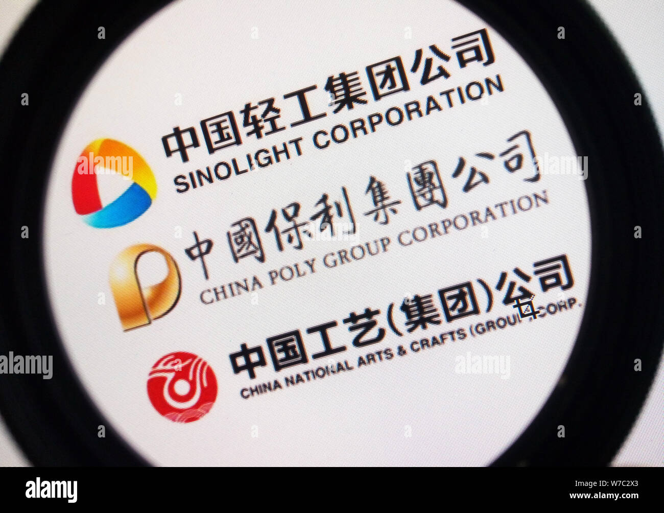 --FILE--A Chinese netizen looks at logos of (from top) Sinolight ...