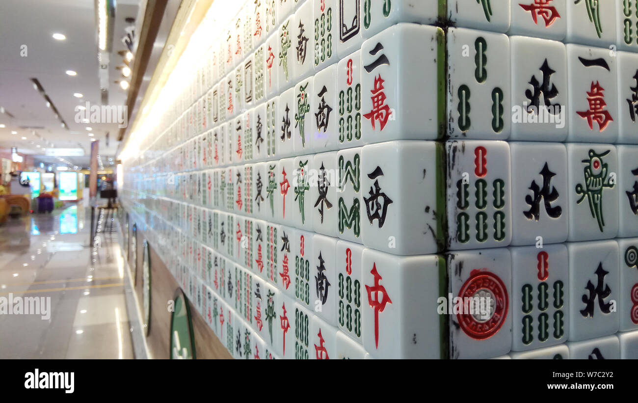 The counter of a beverage outlet is decorated with Mahjong tiles at a ...