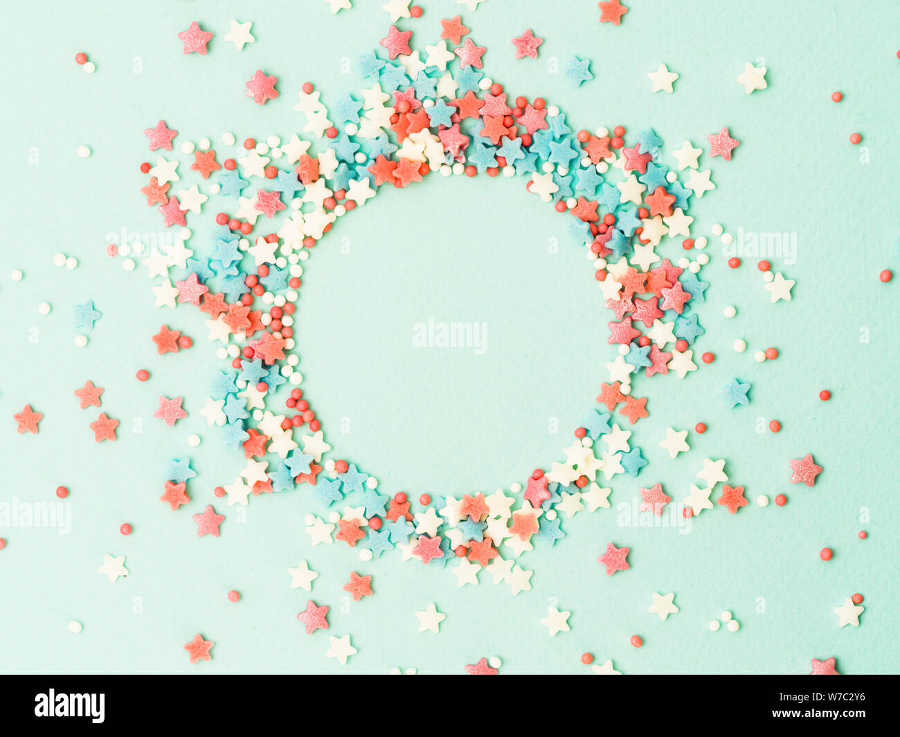 Festive border frame of colorful pastel sprinkles on blue background ...