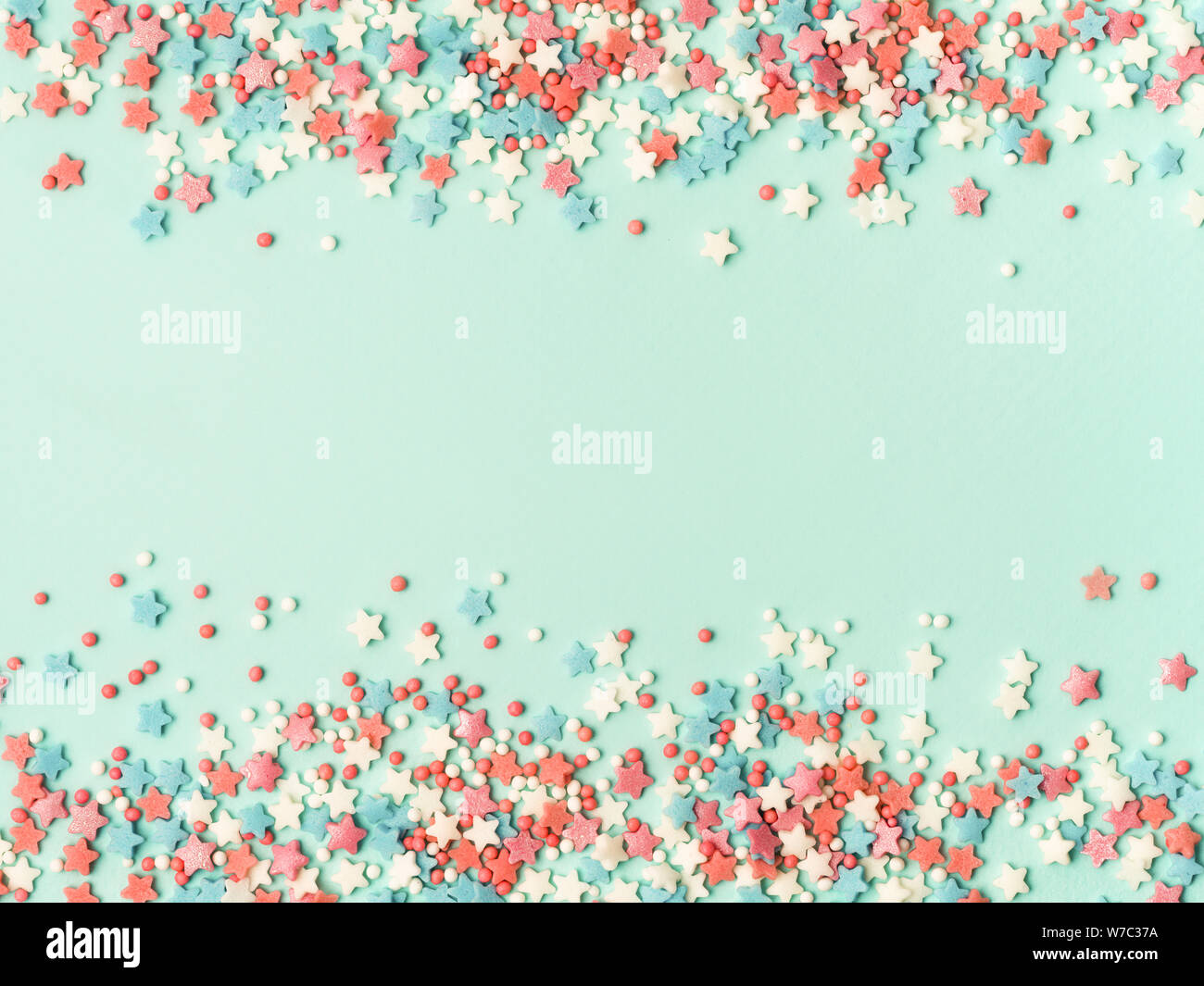 Festive border frame of colorful pastel sprinkles on blue background ...
