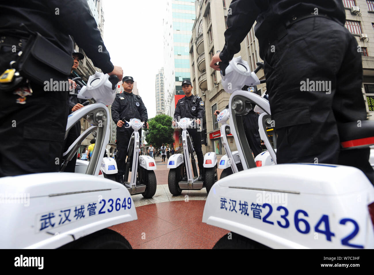 Chinese urban enforcement officers, also known as chengguan, ride self ...