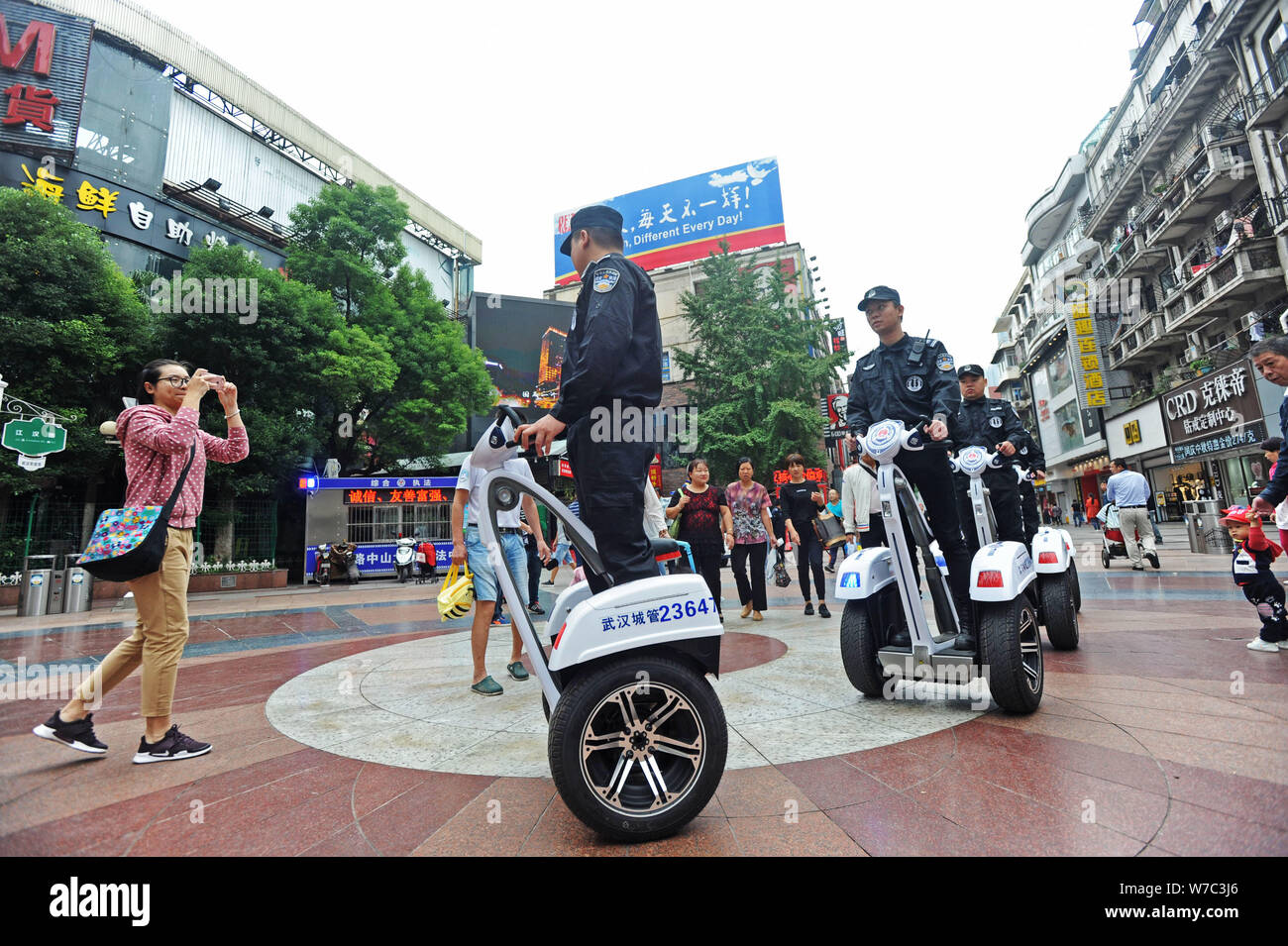 A local resident takes photos of Chinese urban enforcement officers ...