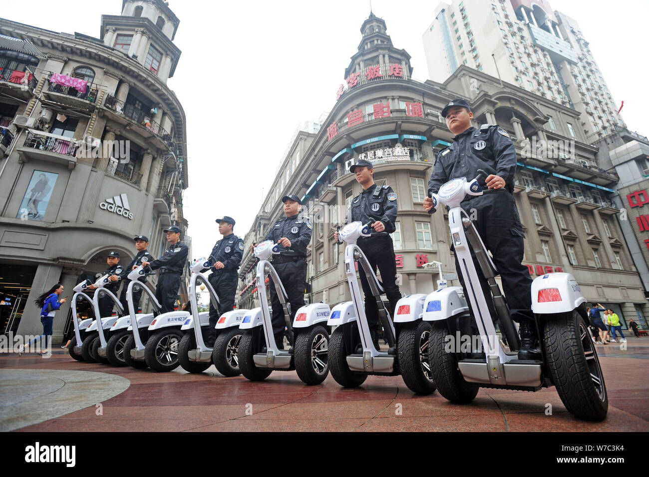 Chinese urban enforcement officers, also known as chengguan, ride self ...
