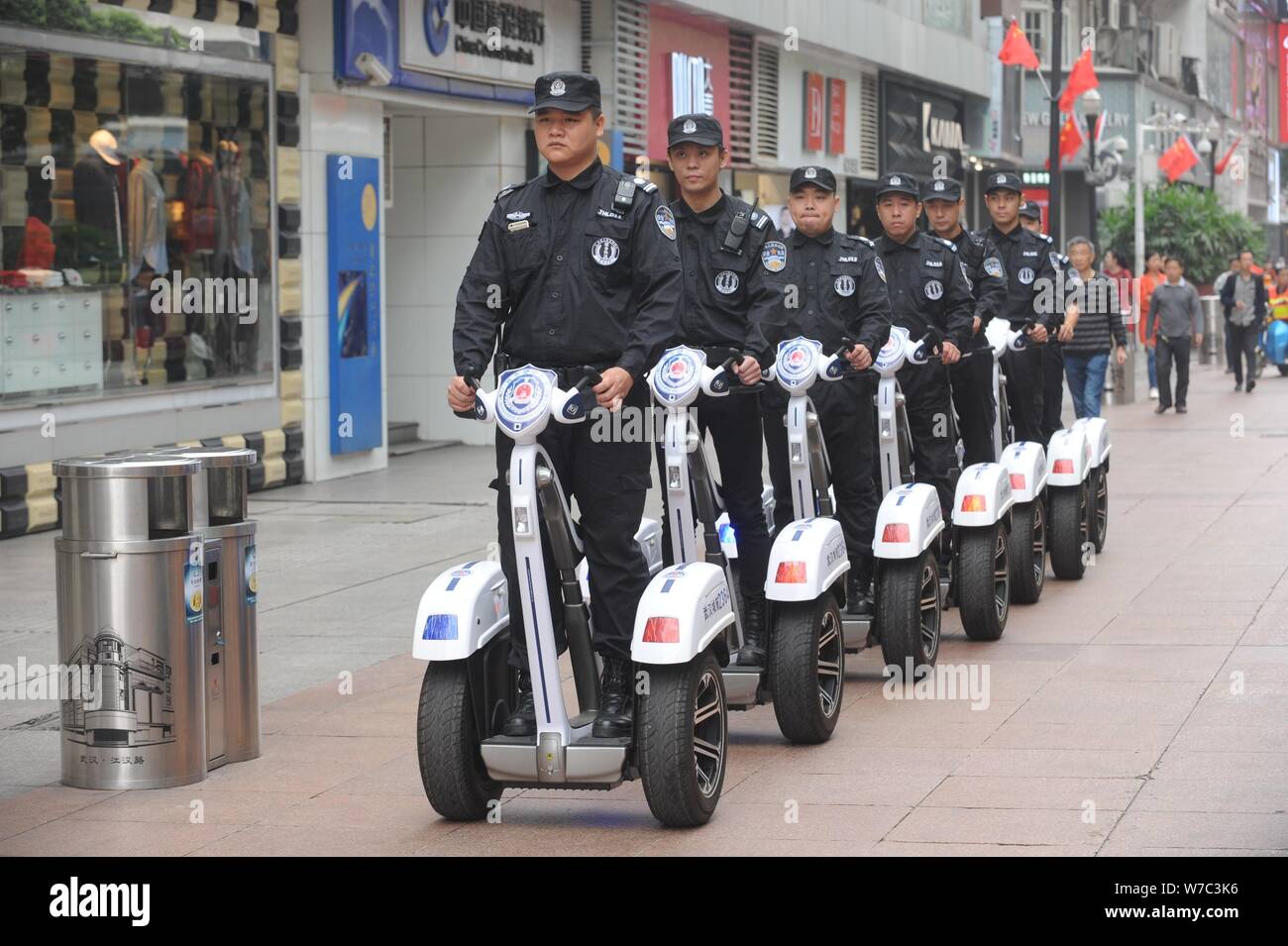 Chinese urban enforcement officers, also known as chengguan, ride self ...