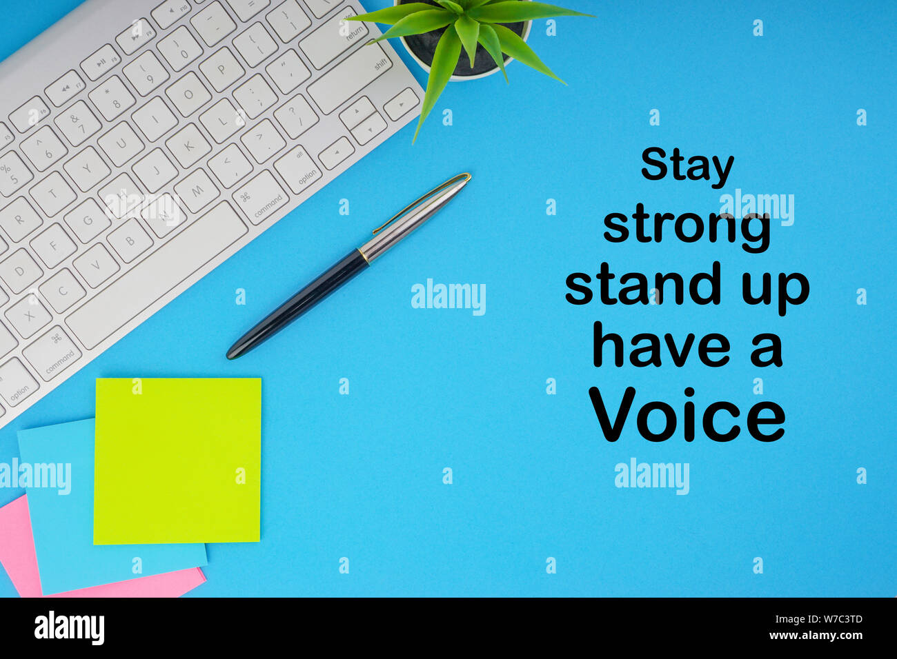 Flat lay, top view office table desk. Workspace with STAY STRONG STAND ...