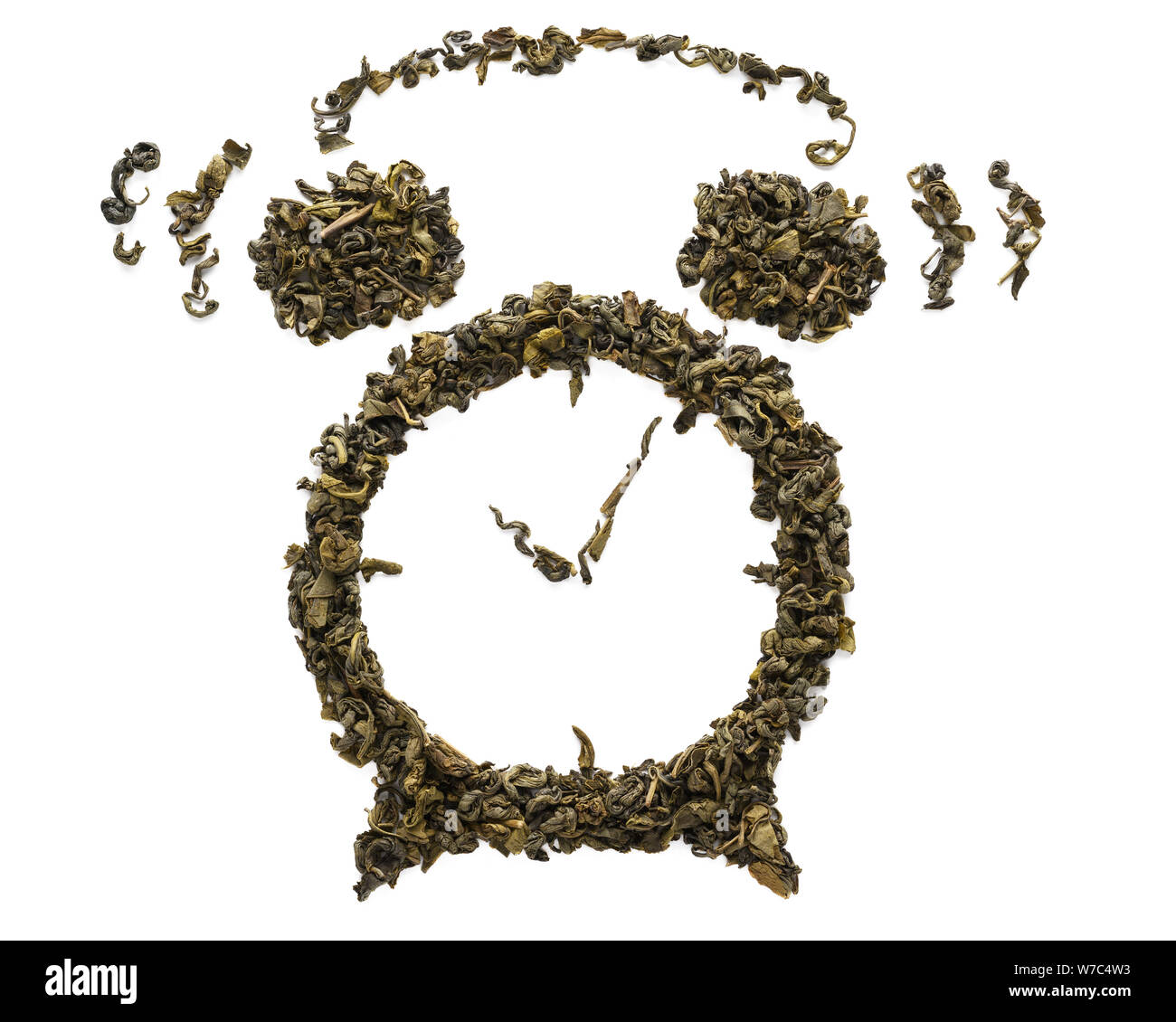 Ringing alarm clock shape made of dry Oolong tea leaves isolated on ...