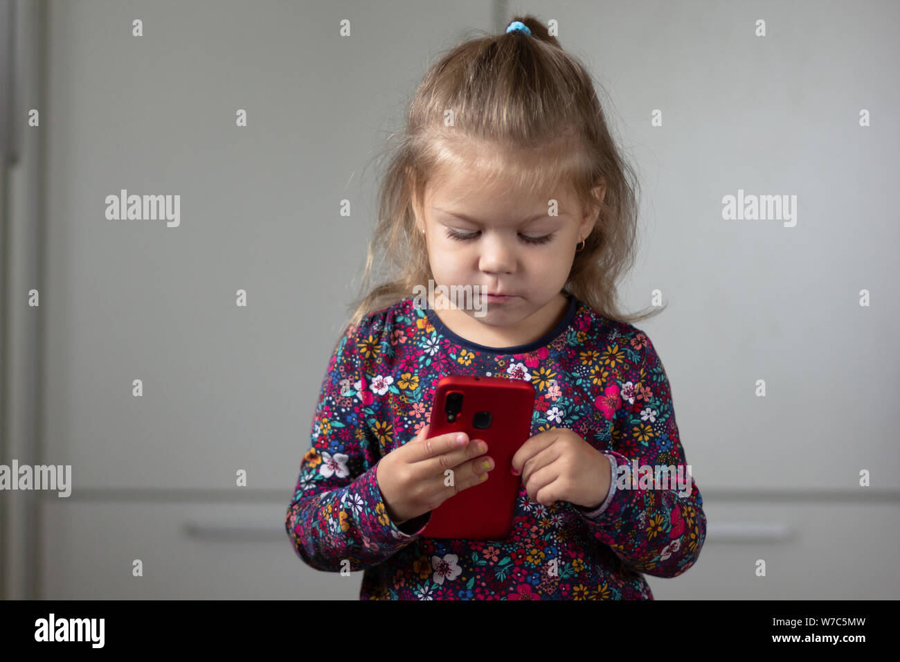 Child looking at mobile hi-res stock photography and images - Alamy