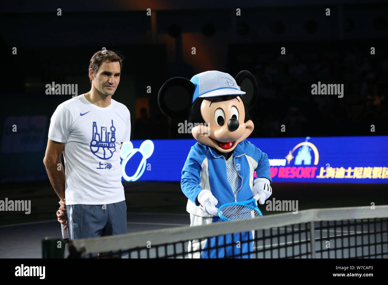 Swiss tennis player Roger Federer, left, is pictured with Mickey Mouse ...