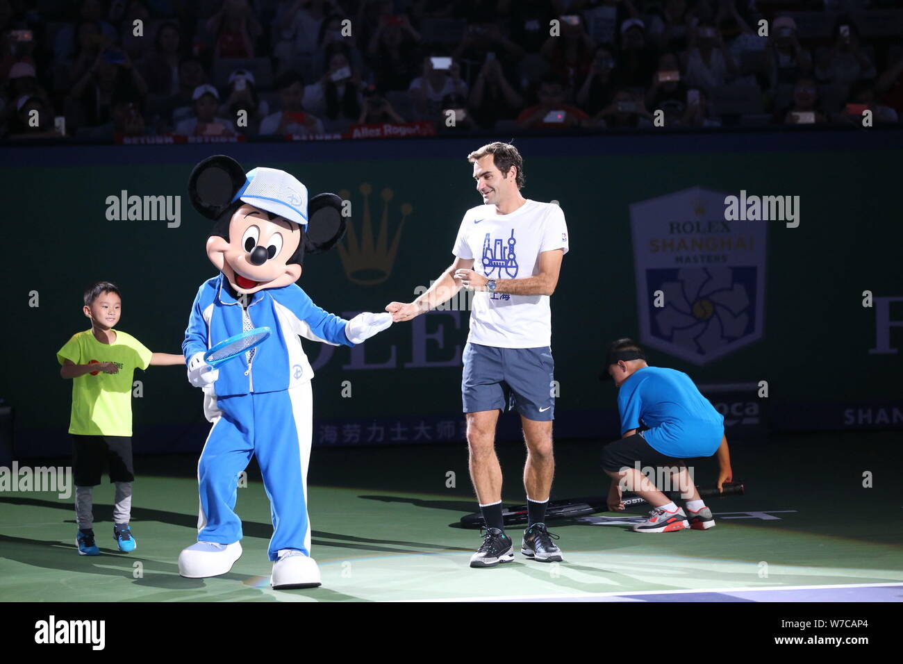 Swiss tennis player Roger Federer enjoys a dance-off with Mickey Mouse ...