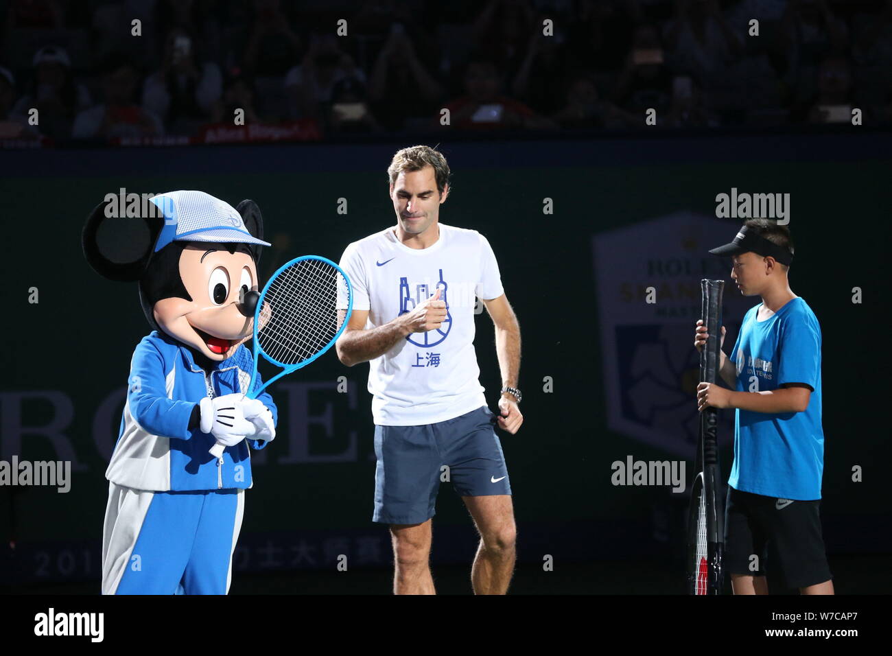 Swiss tennis player Roger Federer enjoys a dance-off with Mickey Mouse ...
