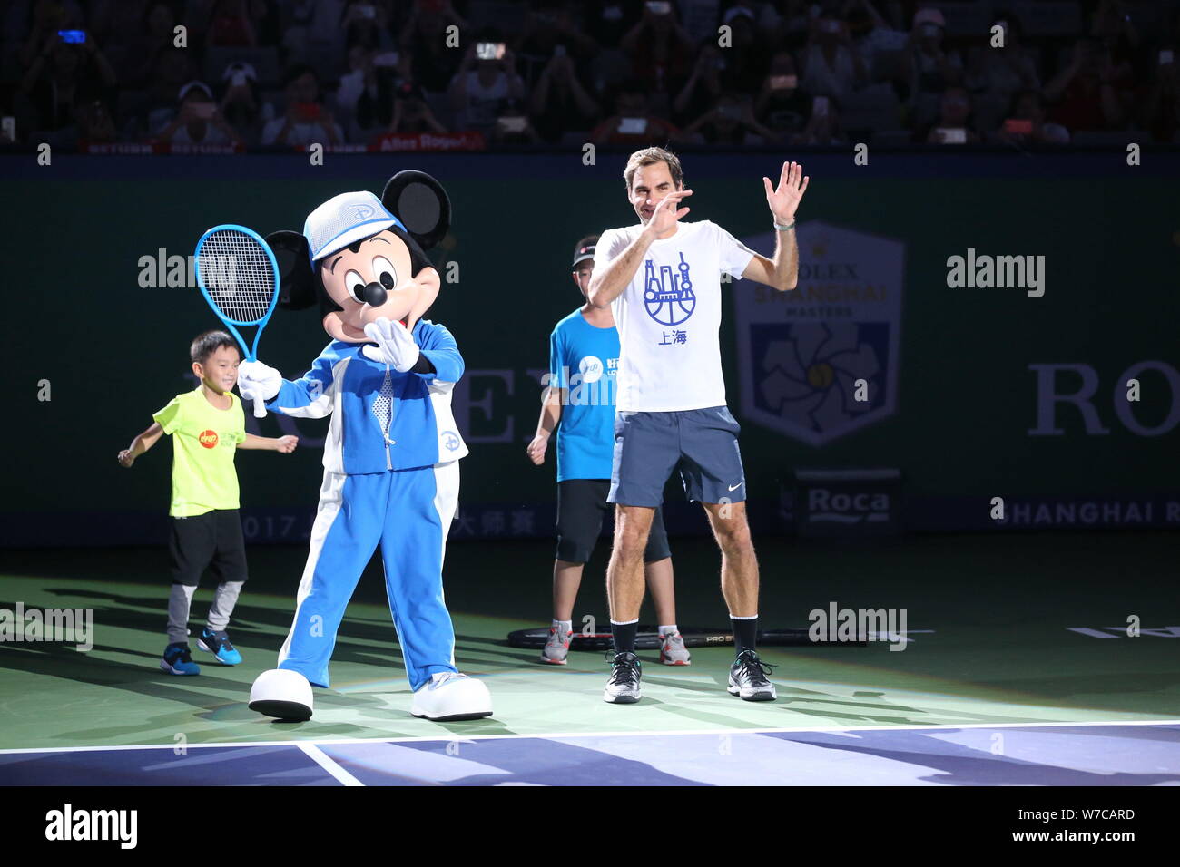 Swiss tennis player Roger Federer enjoys a dance-off with Mickey Mouse ...