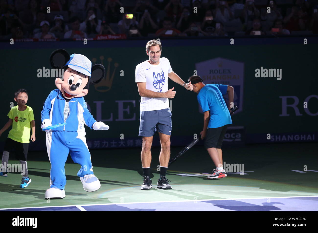 Swiss tennis player Roger Federer enjoys a dance-off with Mickey Mouse ...