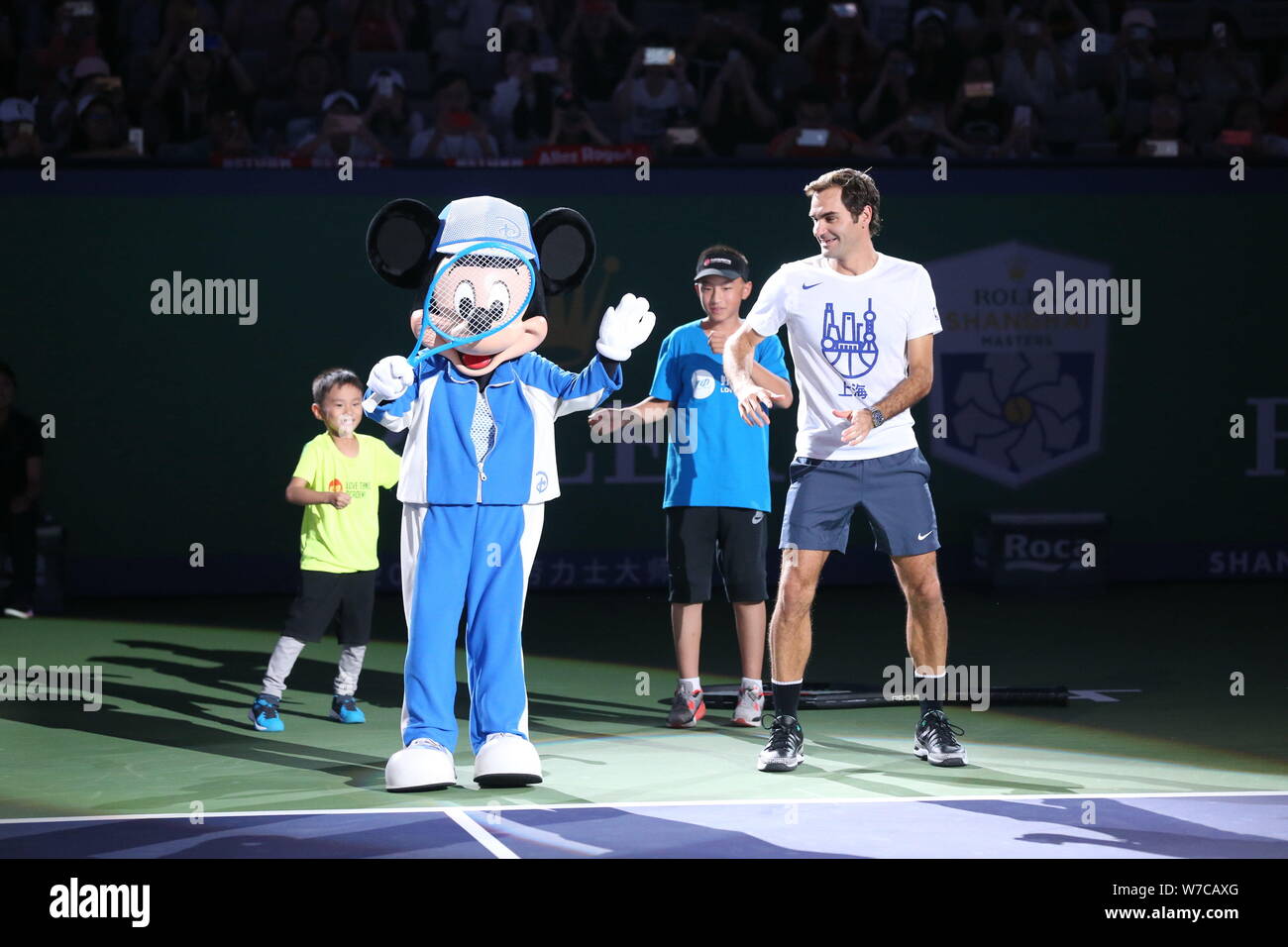 Swiss tennis player Roger Federer enjoys a dance-off with Mickey Mouse ...