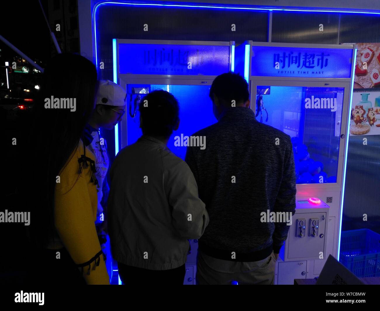 Customers get time capsules from a grabbing machine in the Fotile Time ...