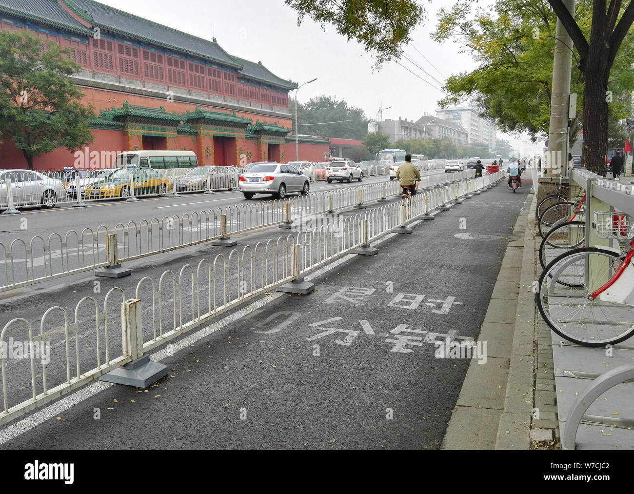 Cyclists ride on the double bicycle lanes in a street near the Beihai ...