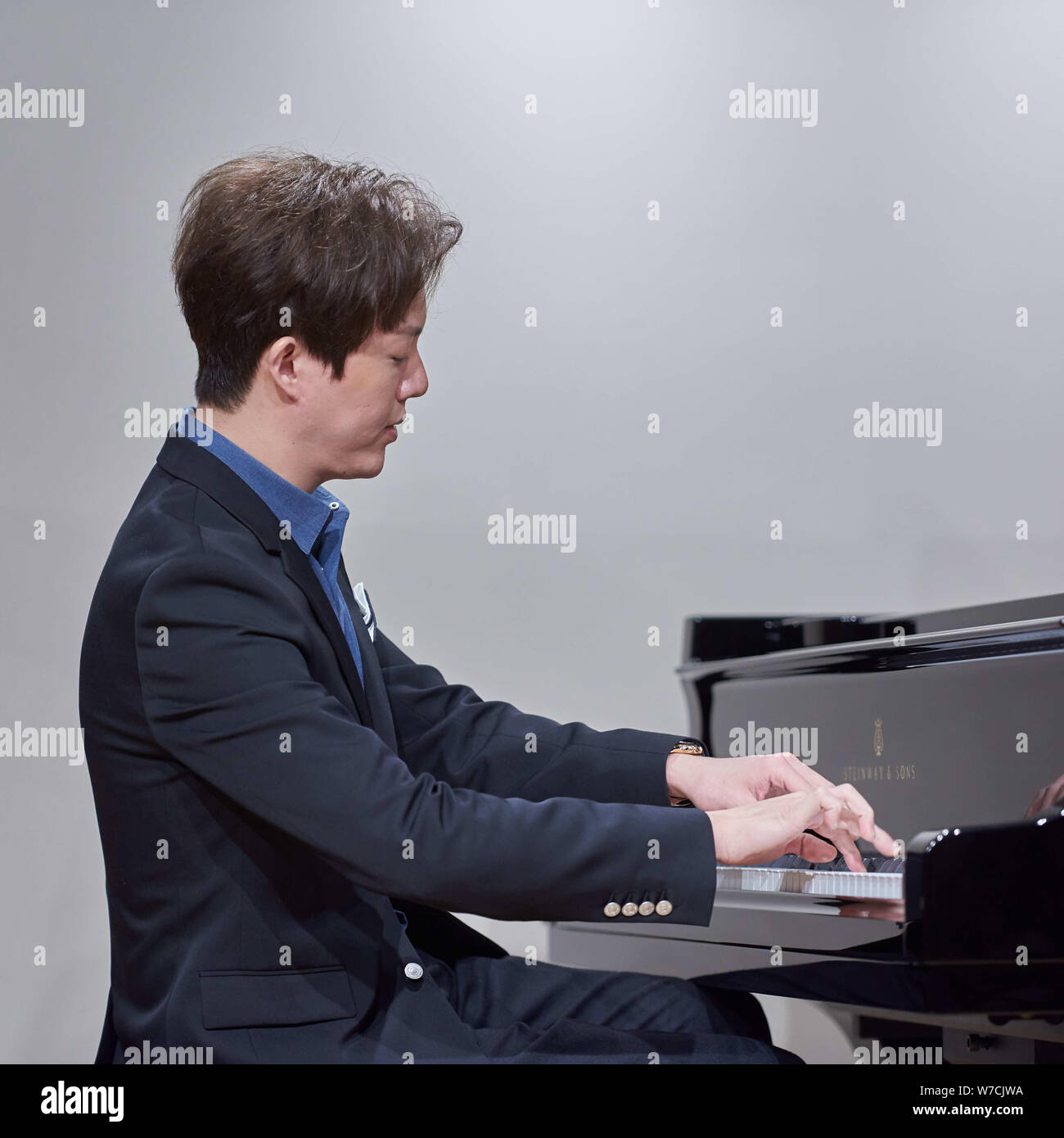 Chinese pianist Li Yundi shows his piano skills during his master class ...