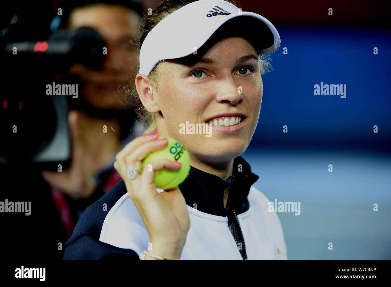 Danish tennis player Caroline Wozniacki throws tennis balls with her ...