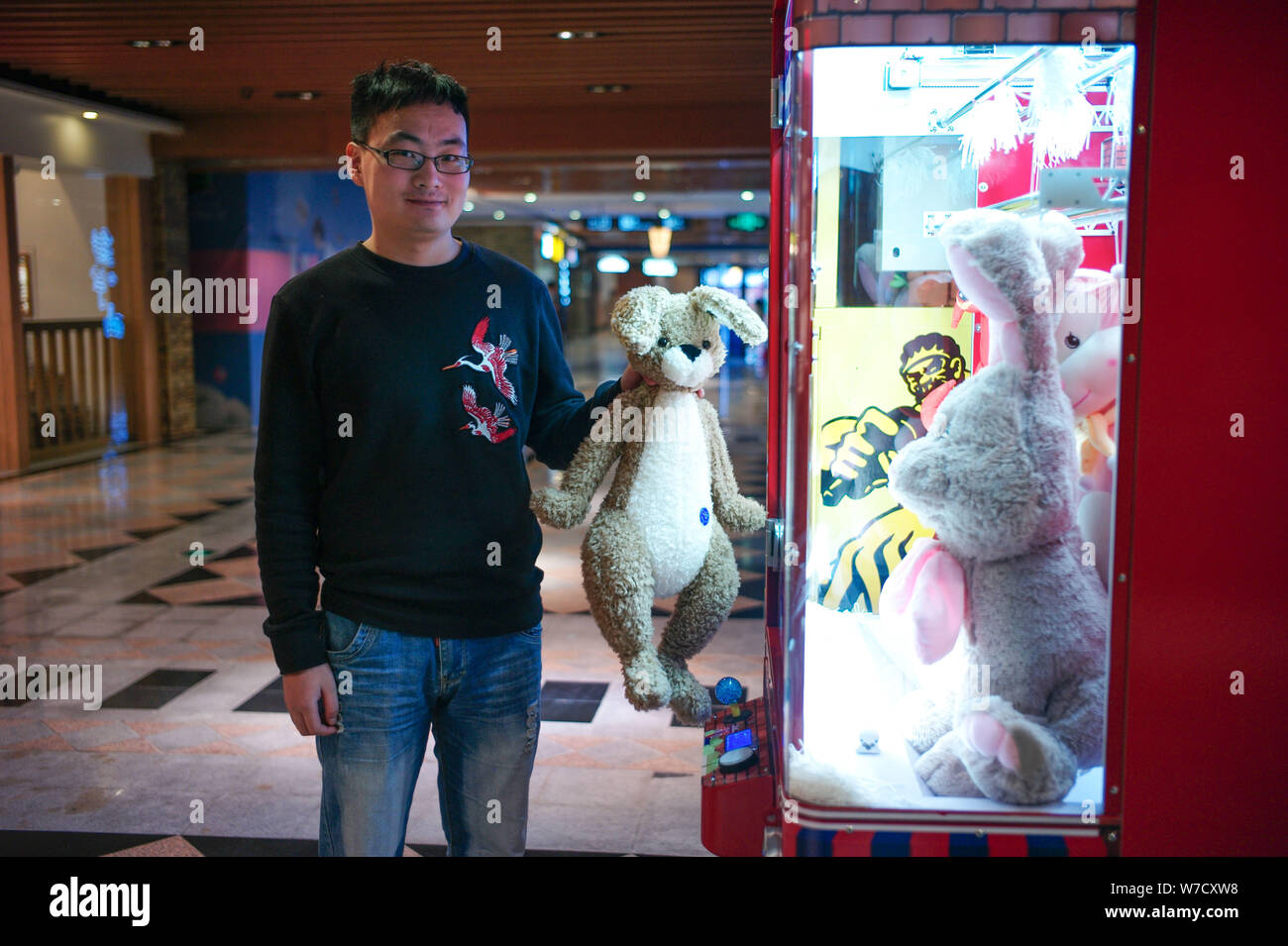 24-year-old Chinese doll-grabbing enthusiast Hu Bo poses with a doll he ...