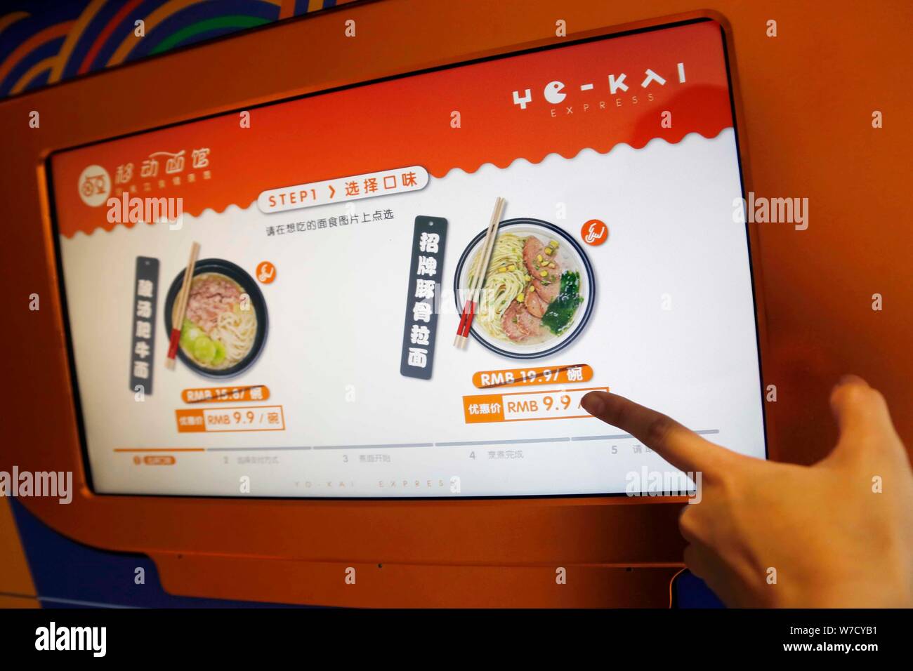 A customer selects the flavor of noodles on a mobile self-service ...