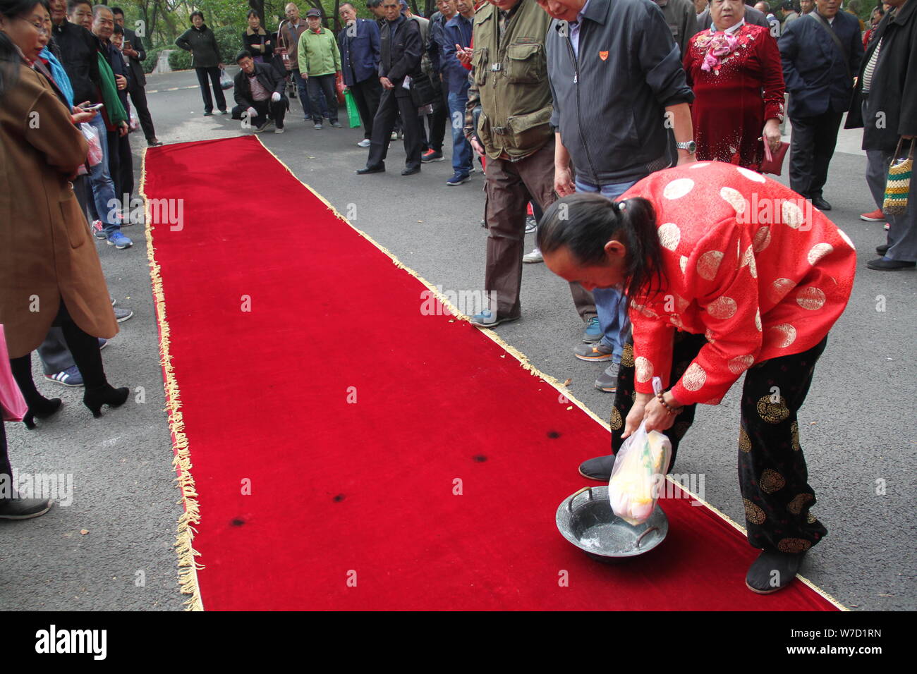 An elderly man prepares to use a bowl of salt to write a 9-meter-long ...