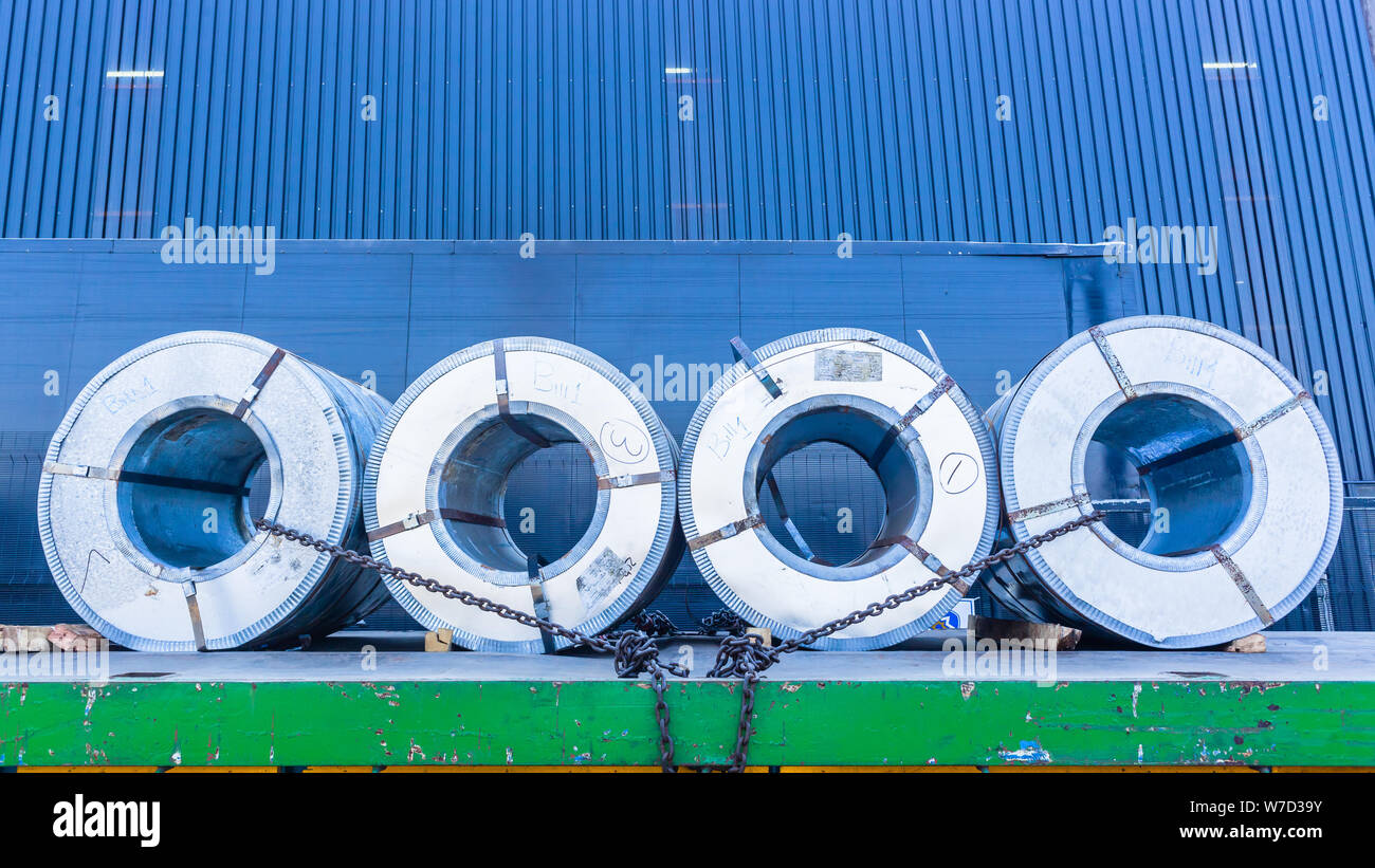 Truck transporting heavy steel sheet rolls secured on trailer from ...