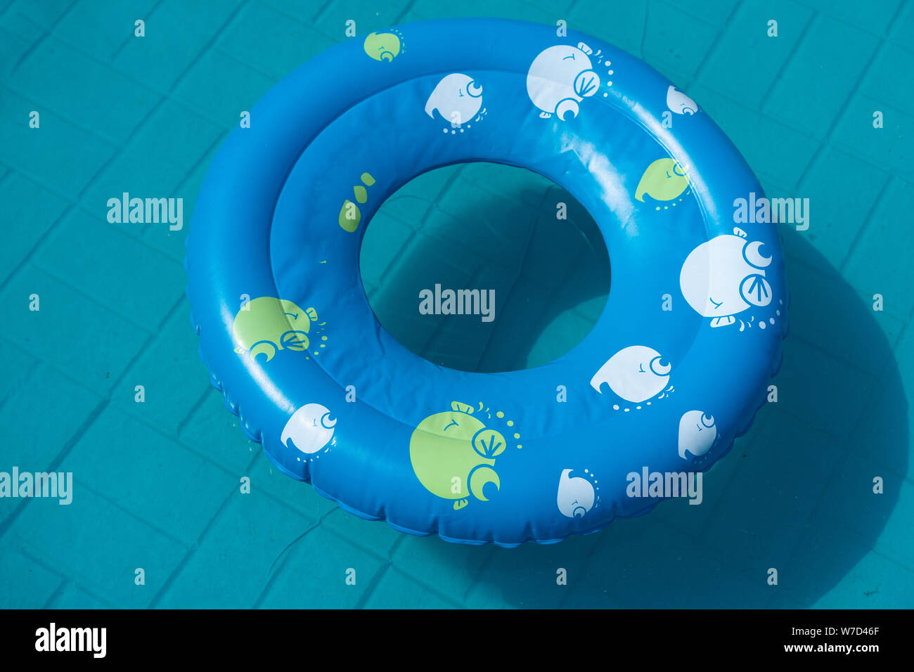 Blue rubber ring lies in the pool in the garden. The concept of summer ...