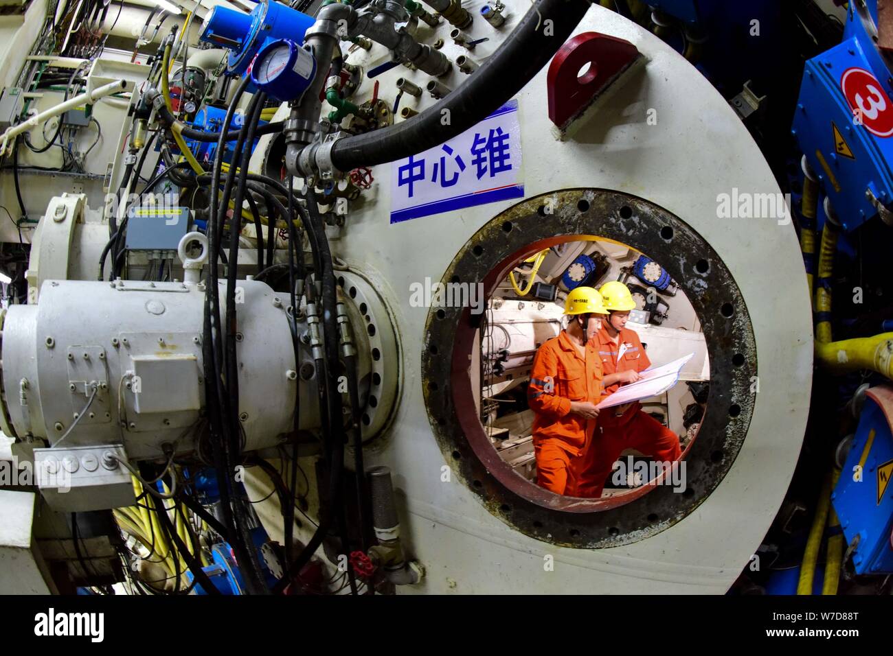 Chinese workers labor at the construction site of the world's first ...