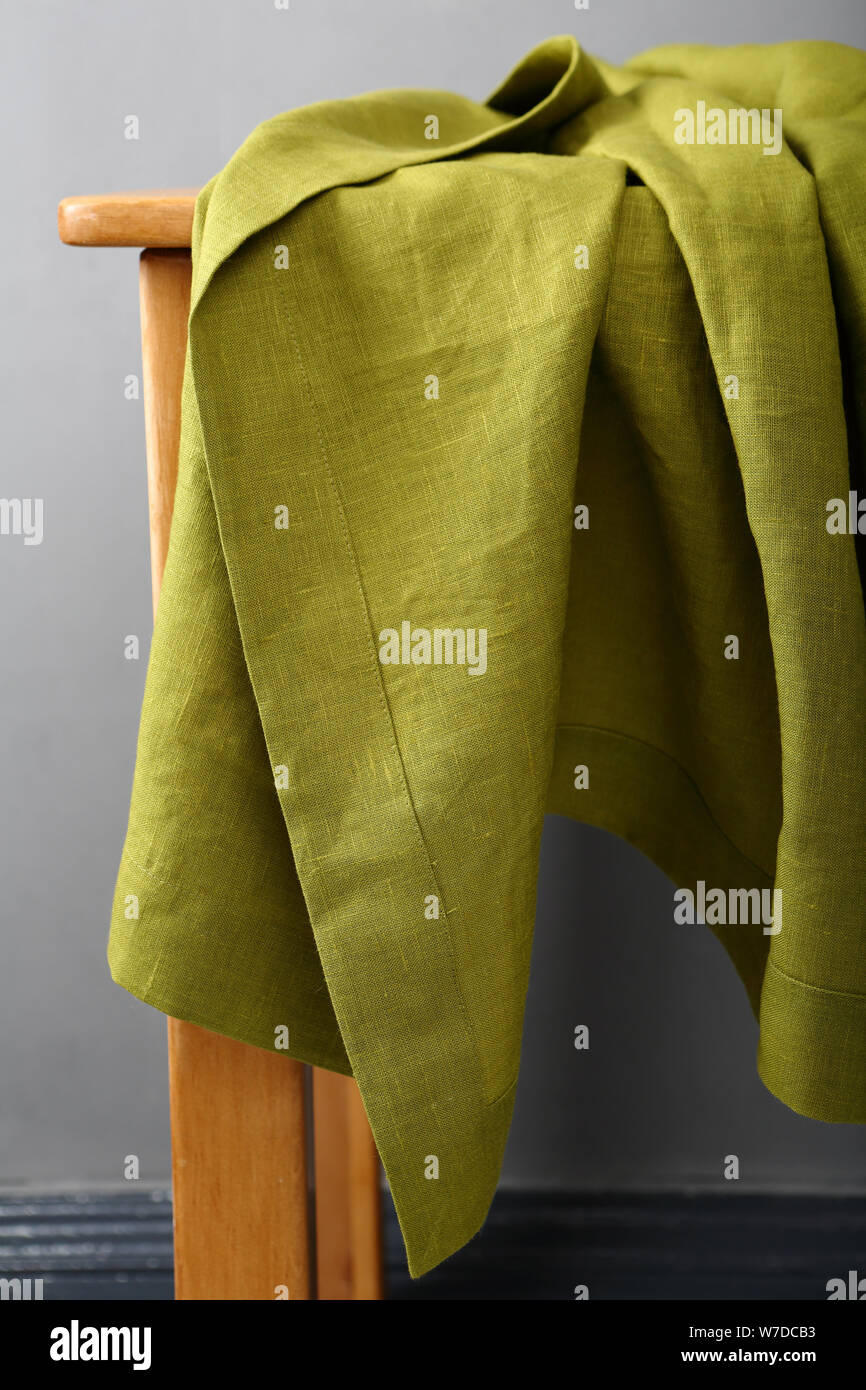 Green tables clothes on wood table Stock Photo - Alamy