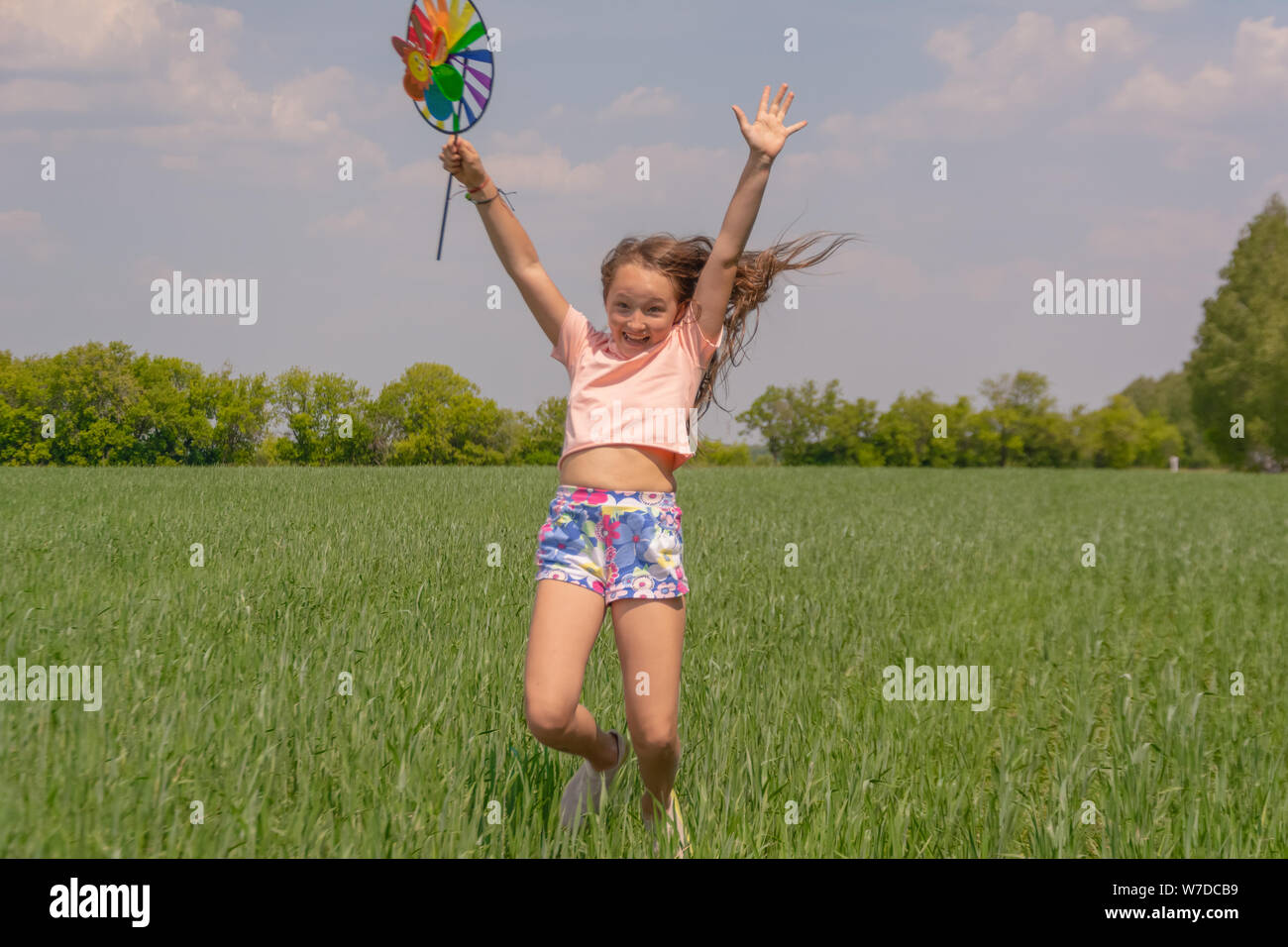 Girl with a pinwheel hi-res stock photography and images - Alamy