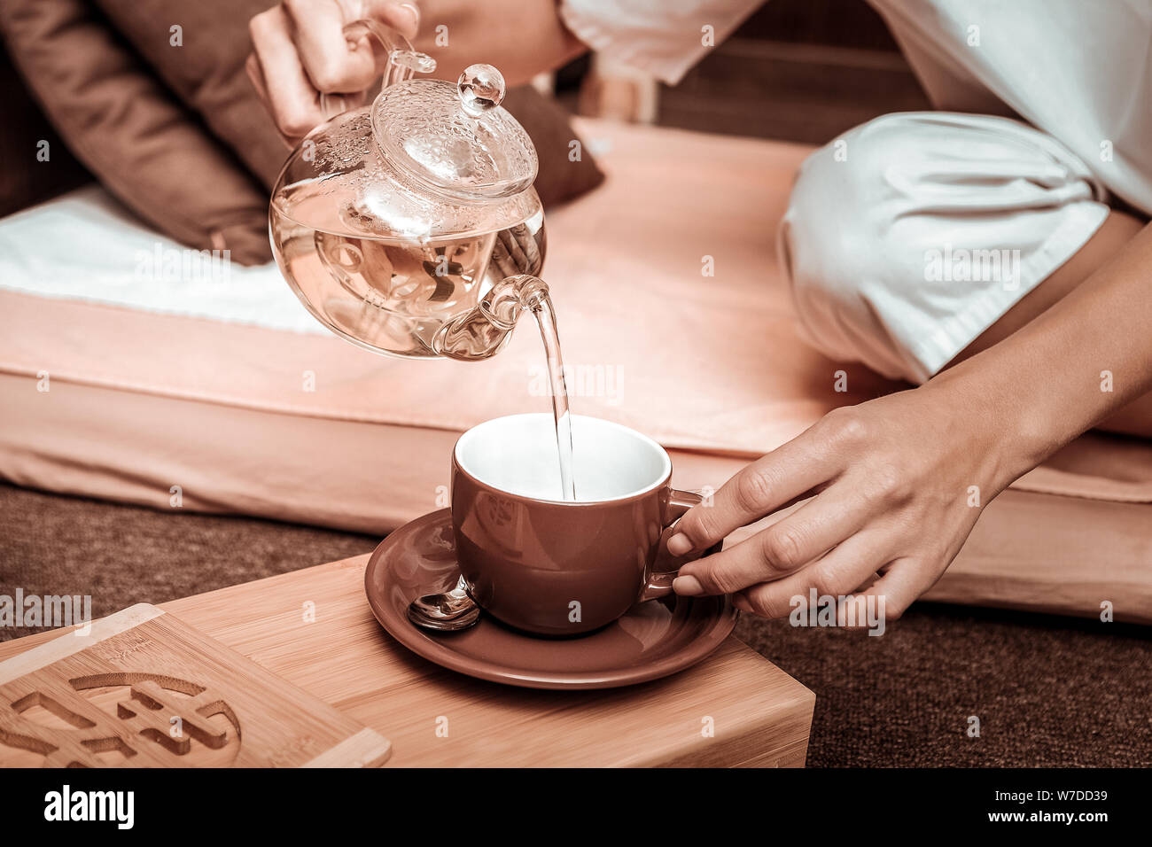 Woman pouring out tea before the tea ceremony Stock Photo - Alamy