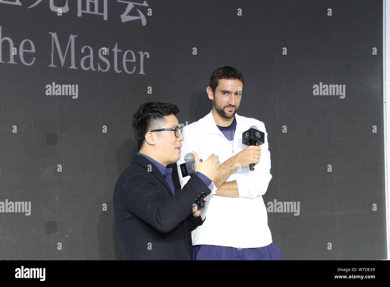 Croatian tennis player Marin Cilic, right, attends a promotional event ...